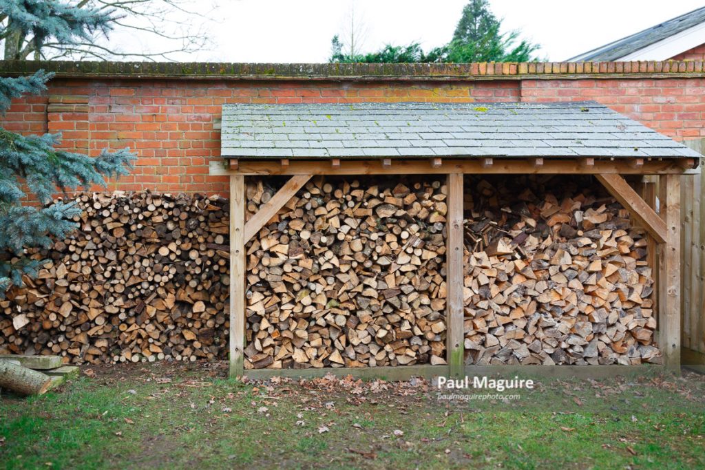 Stock photo - Log store with firewood - Paul Maguire